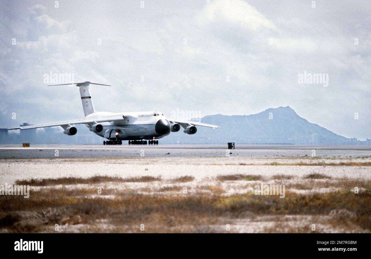 A right front view of a C-5A Galaxy aircraft parked on the runway with ...