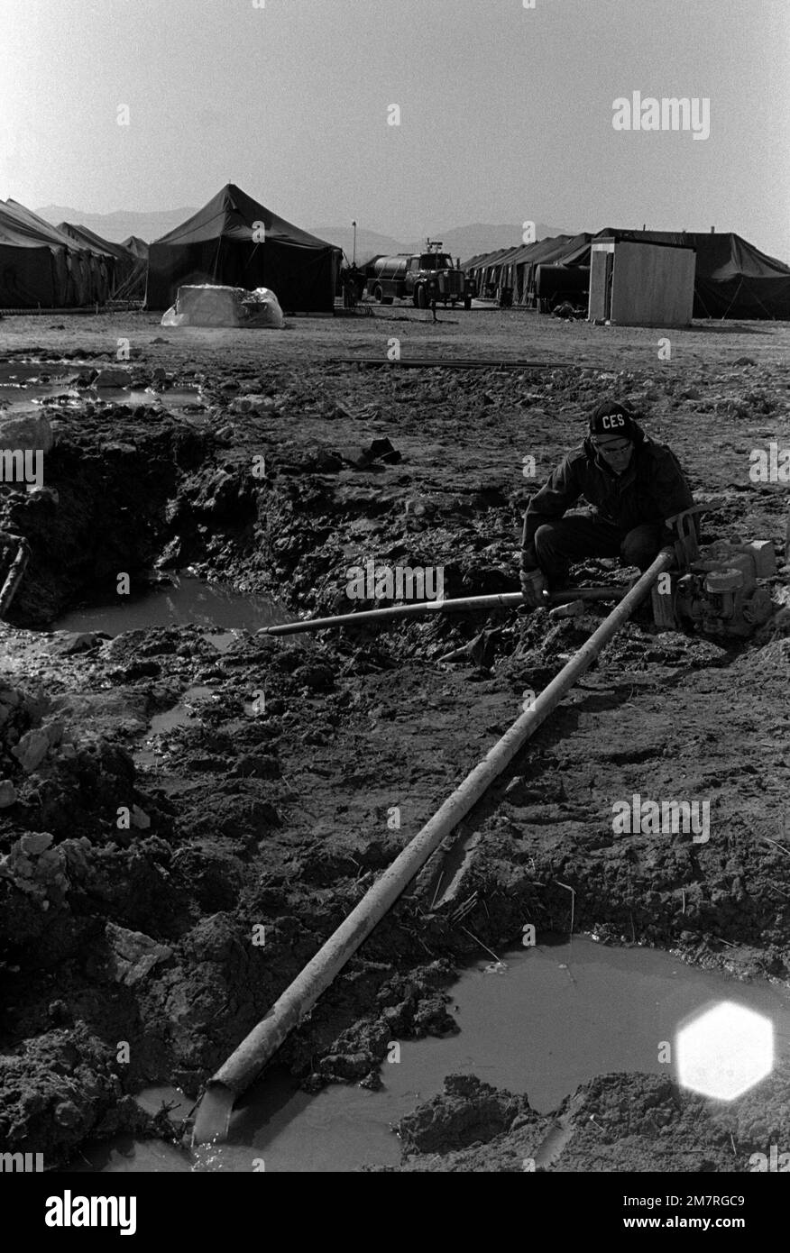 A1C Brumagin pumps water from a ground hole to facilitate repair of a ...
