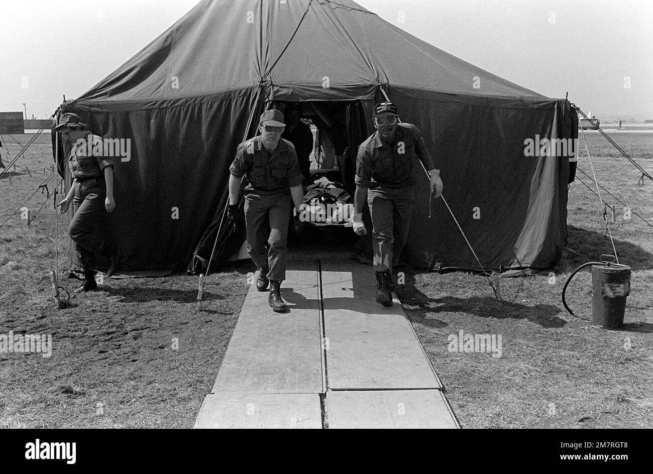 Members of the 1ST Aeromedical Evacuation Squadron carry a "patient ...