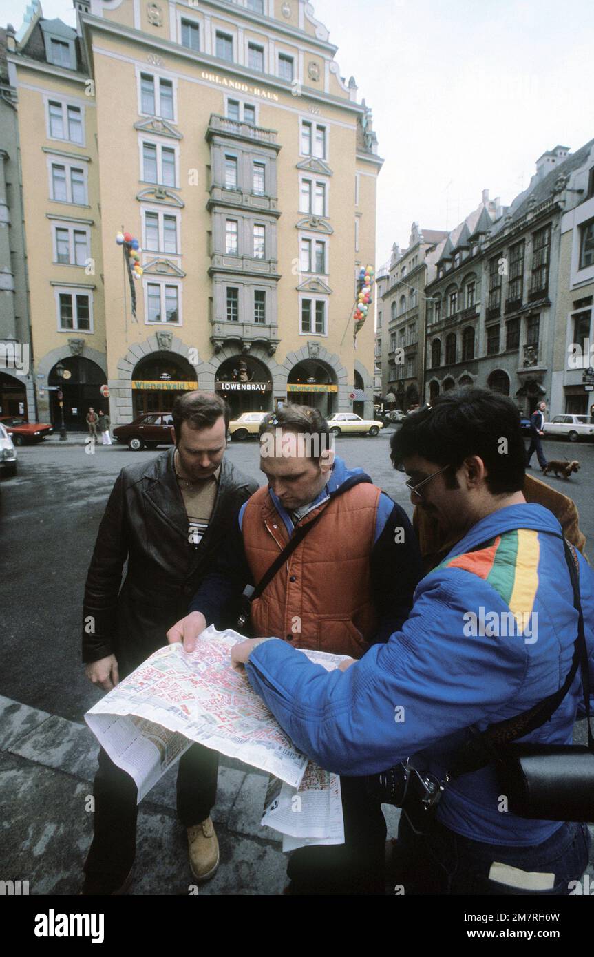 Three men from the 174th Tactical Fighter Wing look over a map of the ...