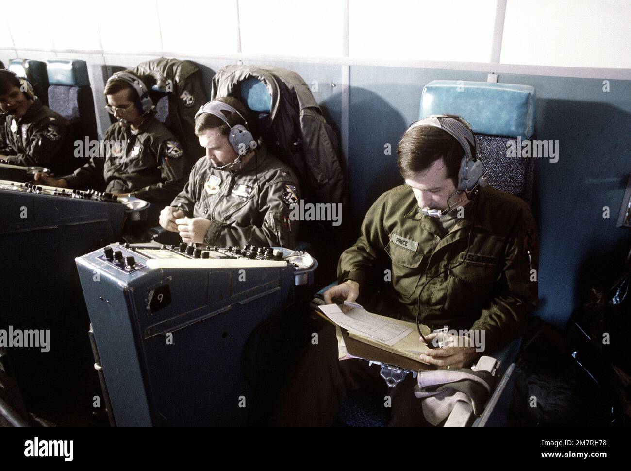 Crew members aboard an EC-130E Hercules aircraft prepare to operate ...