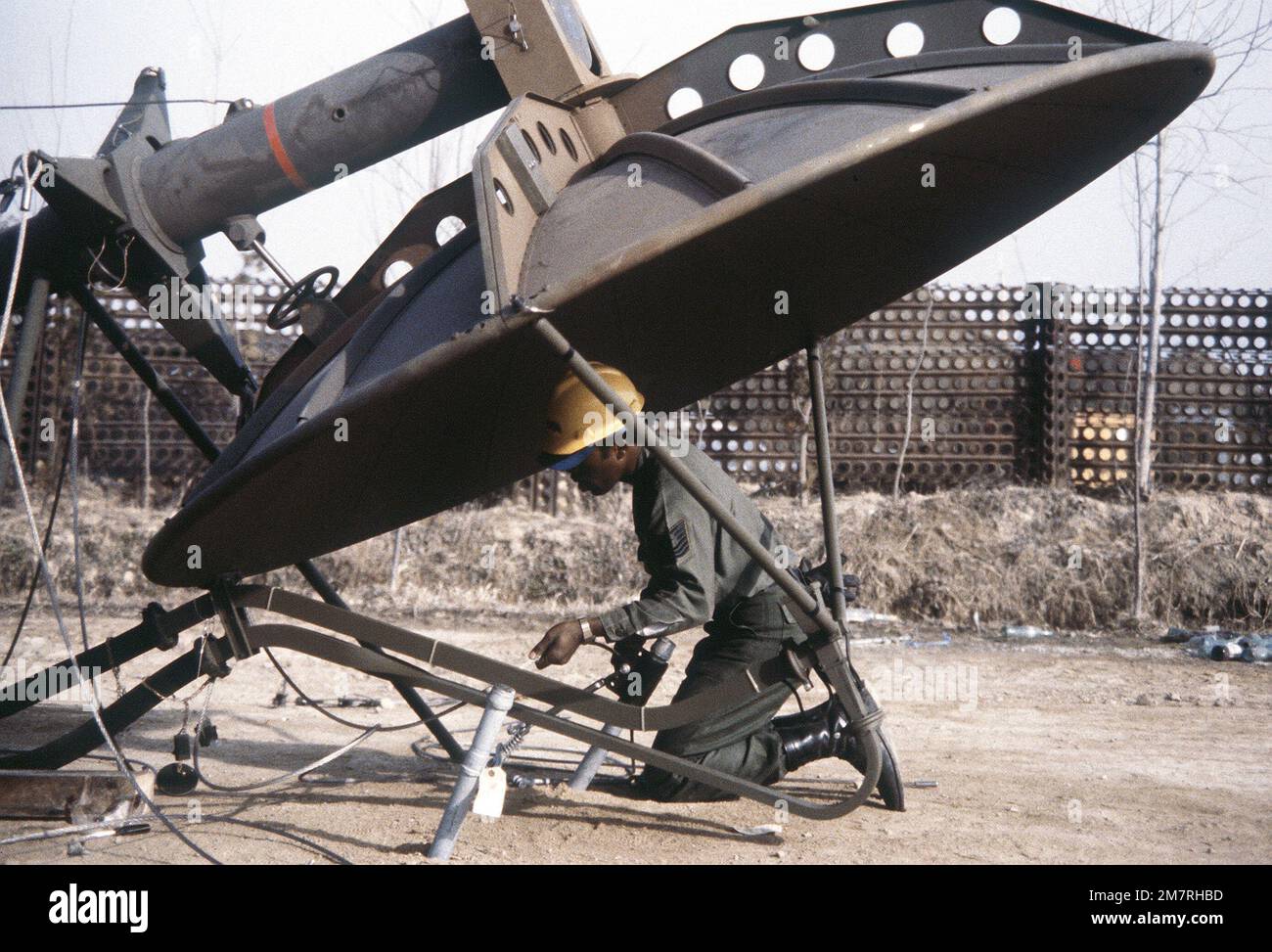 A combat communication group member works on a parabolic TRC-97A radio ...