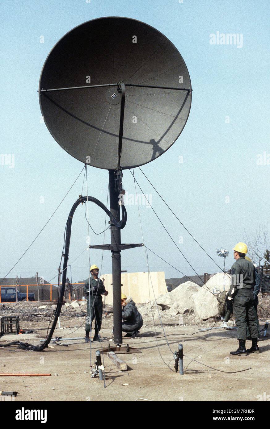 A combat communication group member erects a parabolic TRC-97A radio ...