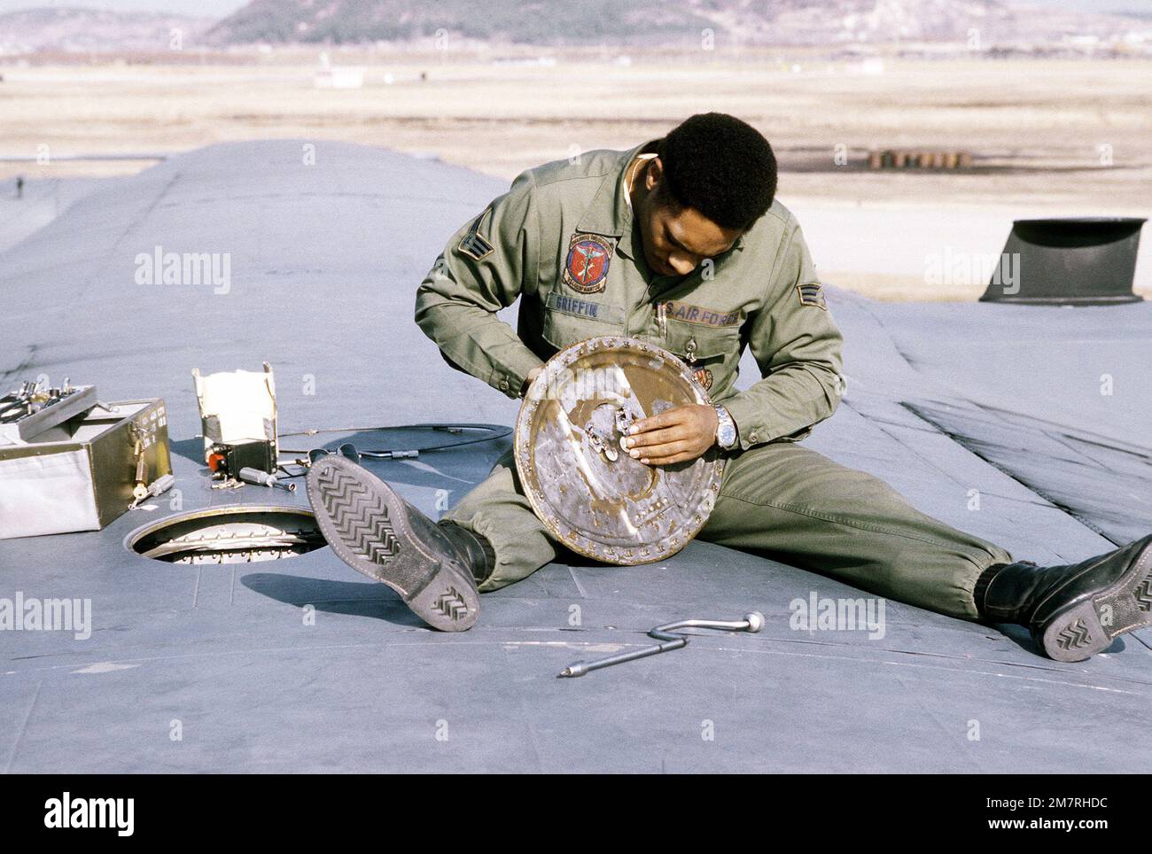 SGT Earl E. Griffin works on an AC-130H Hercules aircraft wing access ...