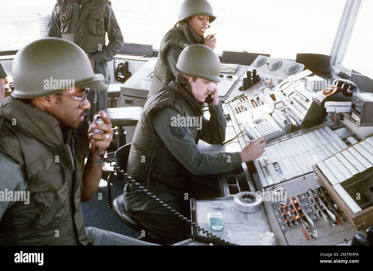 Air traffic controllers, in the control tower, are in contact with ...
