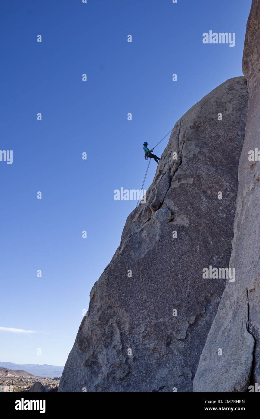 Woman abseiling down cliff hi-res stock photography and images - Alamy