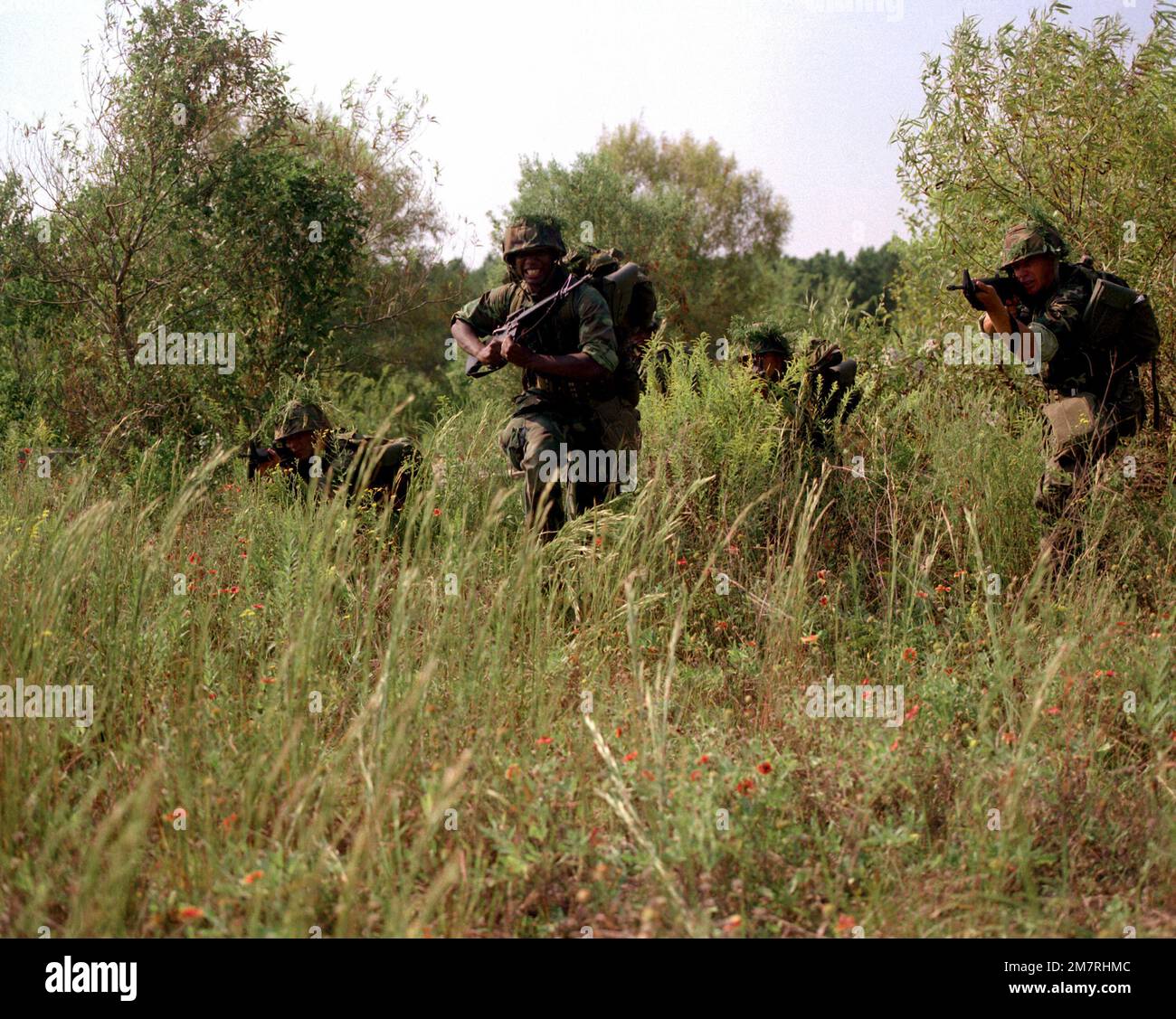 One member of the fire team rushes forward as the other members ...