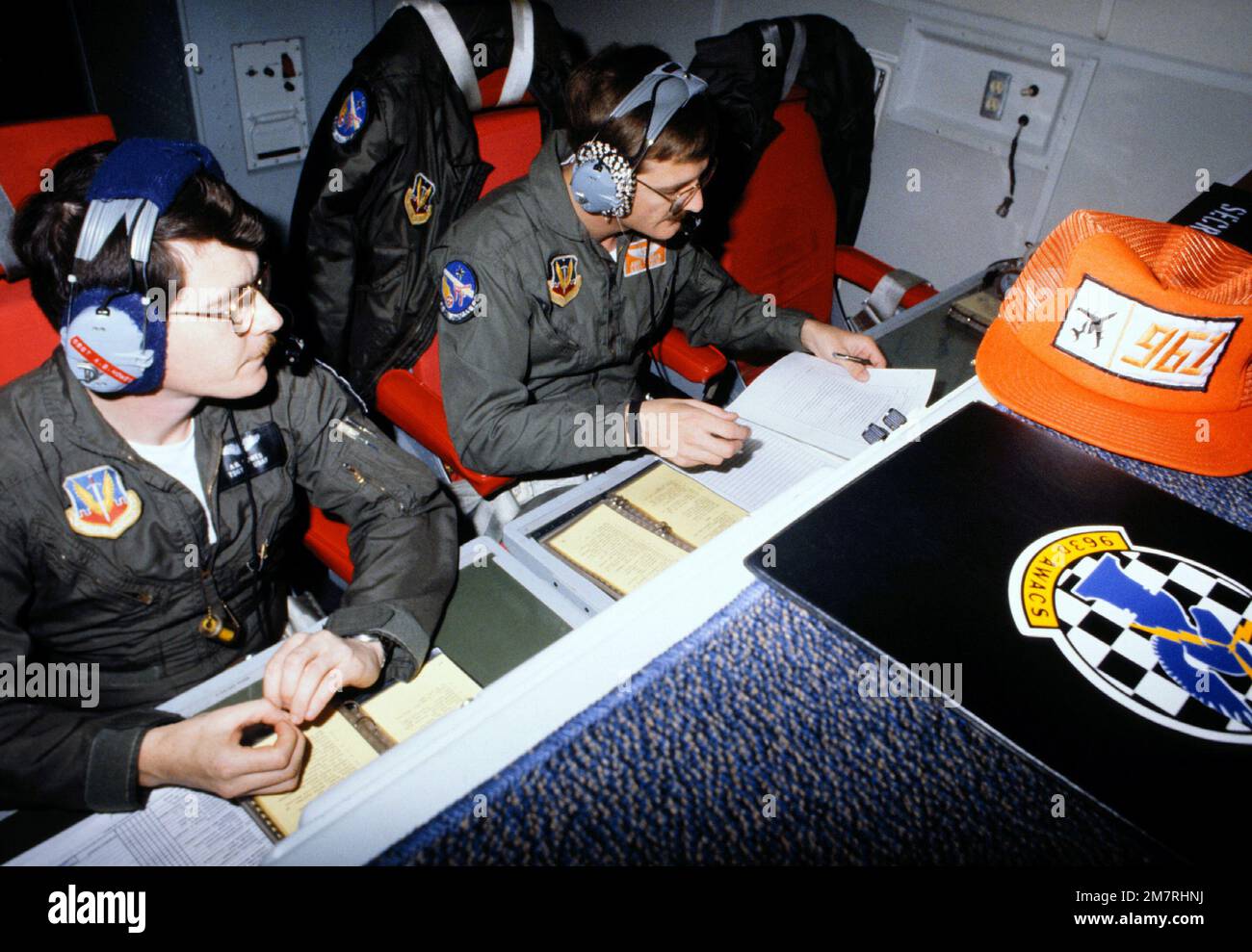 Crewmen monitor control panels aboard an E-3A Sentry Airborne Warning ...