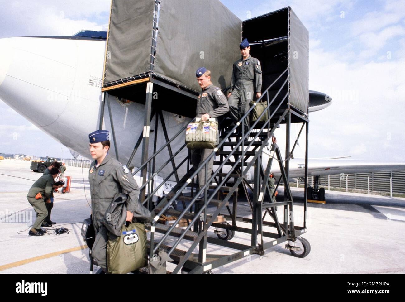 Crewmen debark an E-3A Sentry Airborne Warning and Control System ...