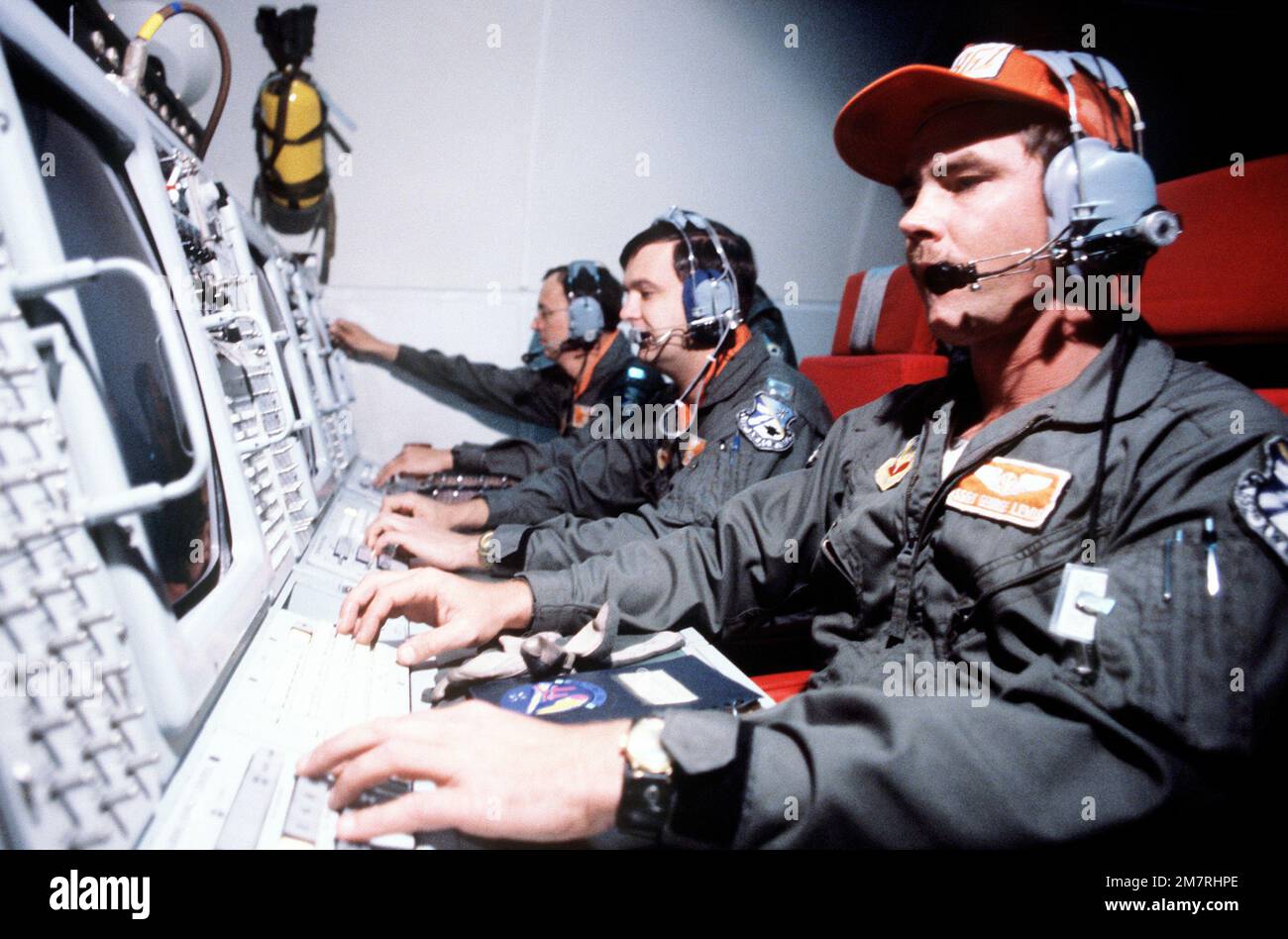 Crewmen monitor control panels aboard an E-3A Sentry Airborne Warning ...