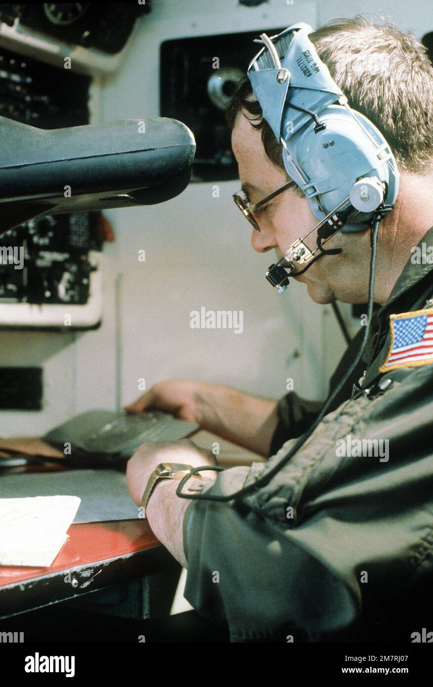 An officer aboard a C-130 Hercules aircraft monitors airdrops during ...