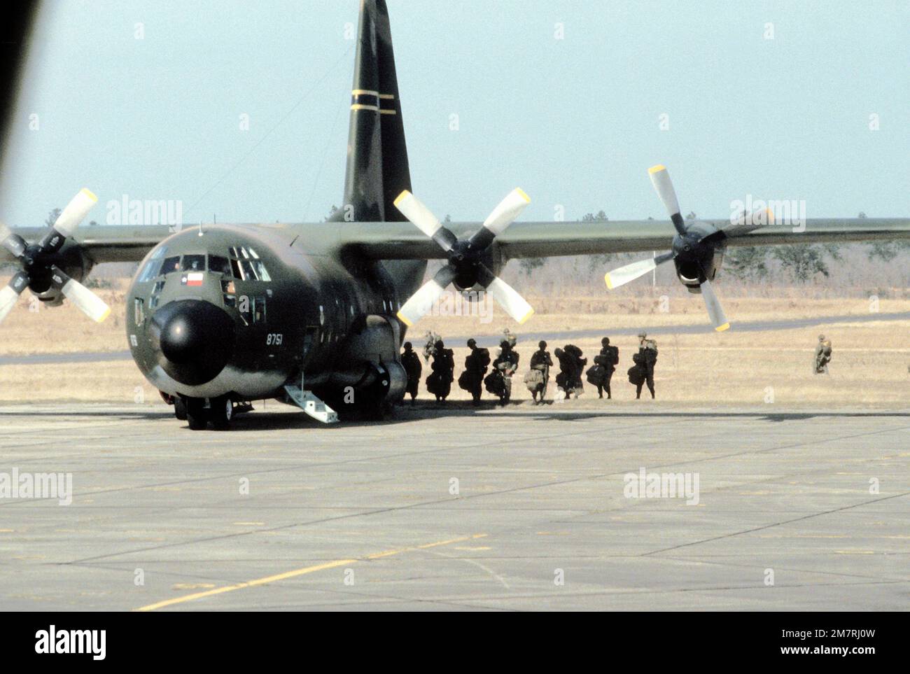 Troops board an Air National Guard C-130 Hercules aircraft during ...