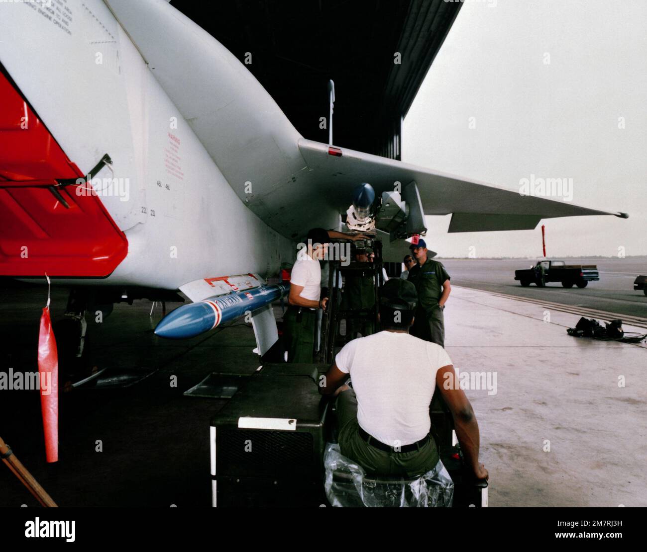 Air Force technicians load two inert Raytheon versions of the advance ...