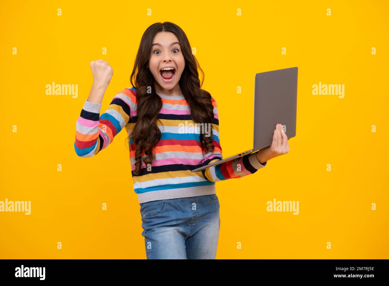 Amazed teenager. Teenager school girl hold notebook laptop. School ...