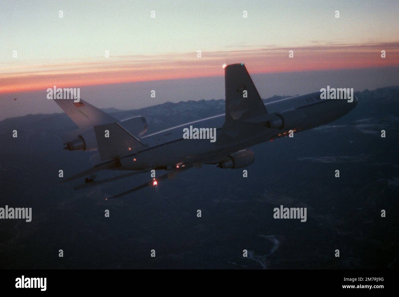 AN air-to-air right rear view of a KC-10A Extender aircraft banking to ...