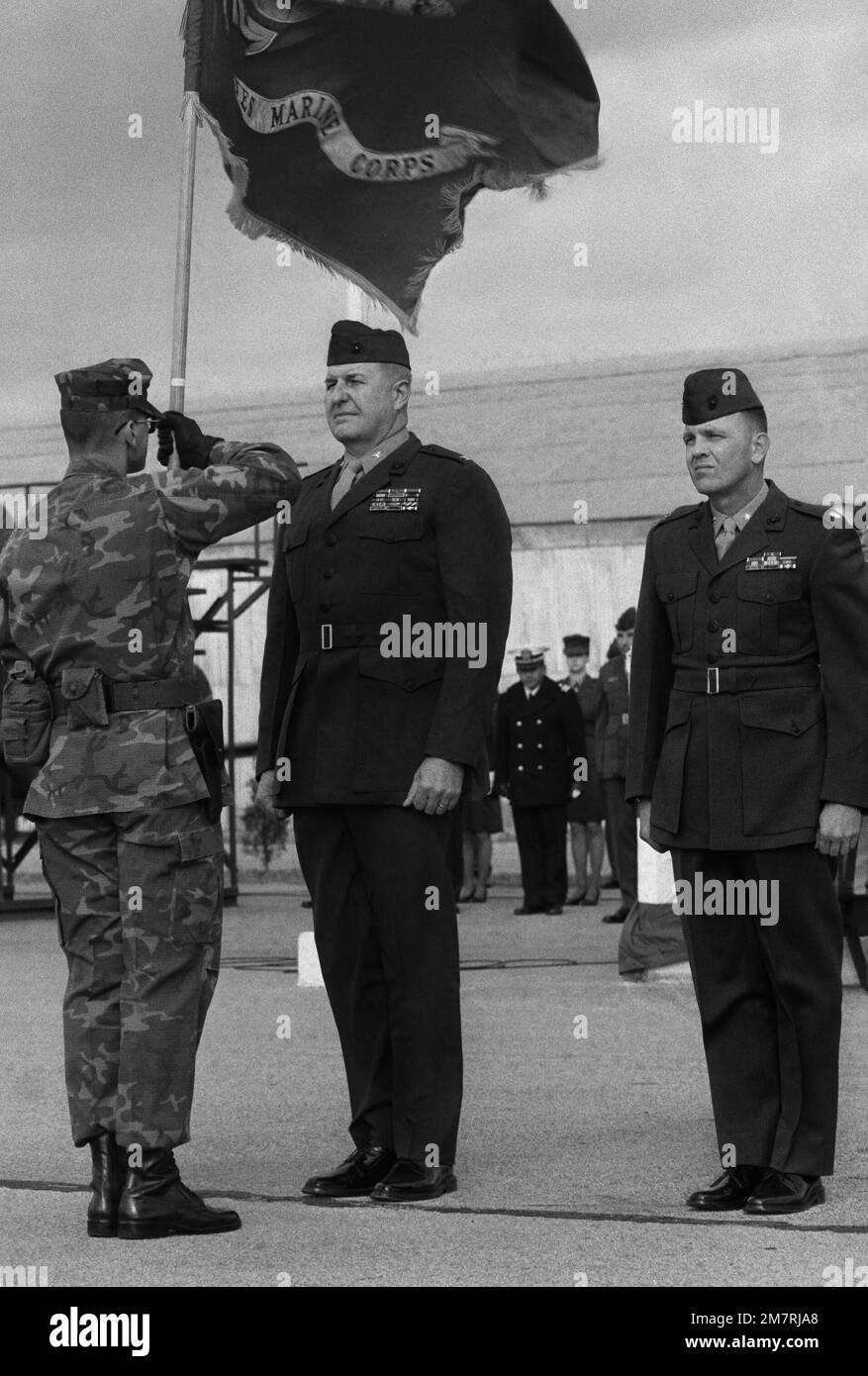 Colonel Joseph B. Knotts, center, prepares to receive the colors from ...
