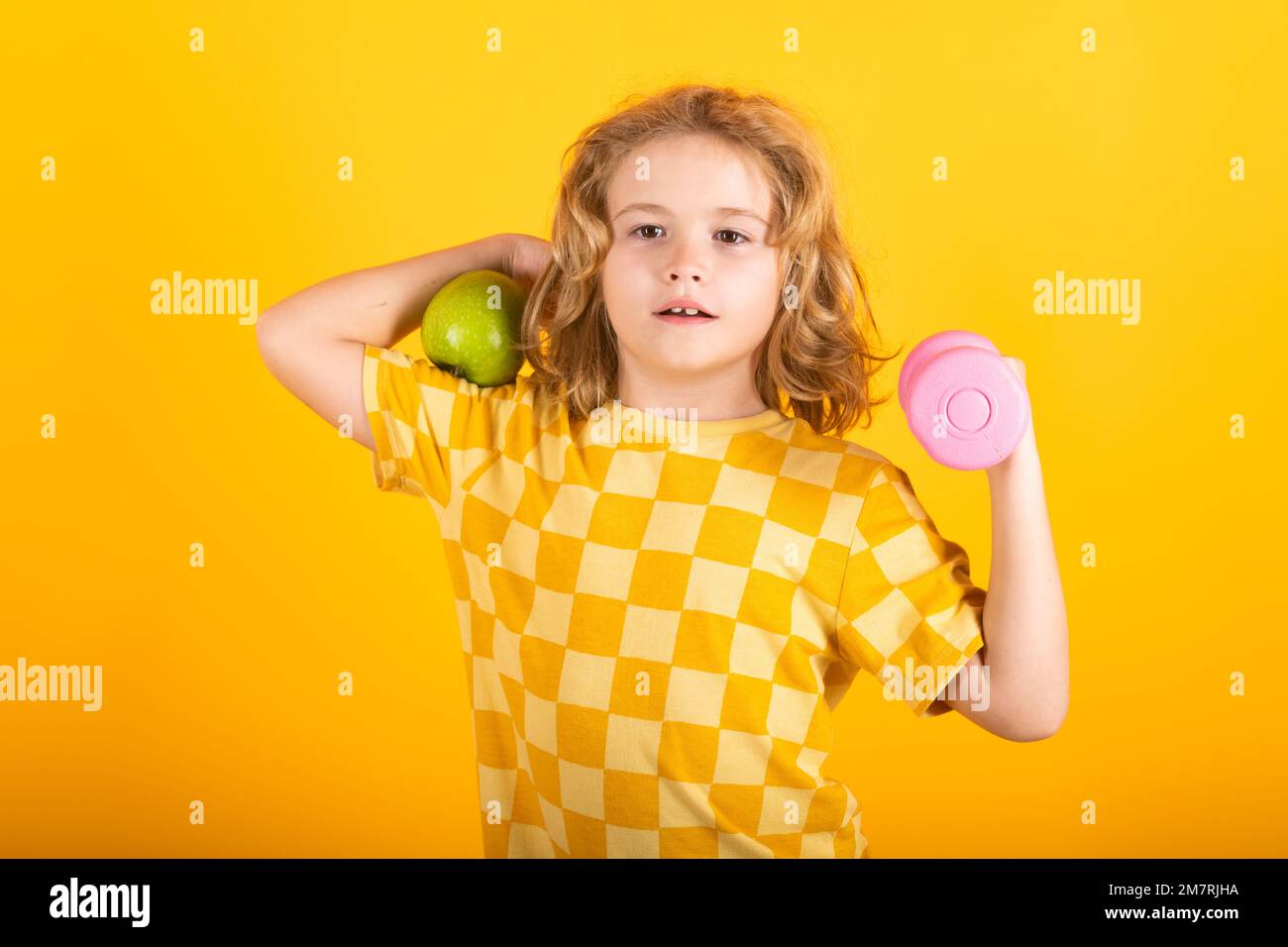 Cute little boy doing exercises with dumbbells. Portrait of sporty ...