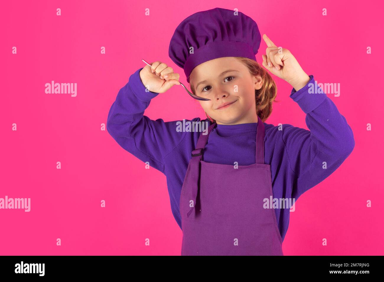 Funny kid chef cook with spoon. Portrait of little child in uniform of ...