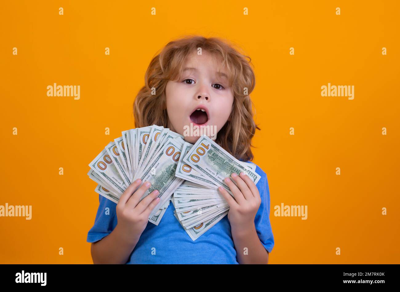 Kid showing money dollar bills, standing dreamy of rich against ...