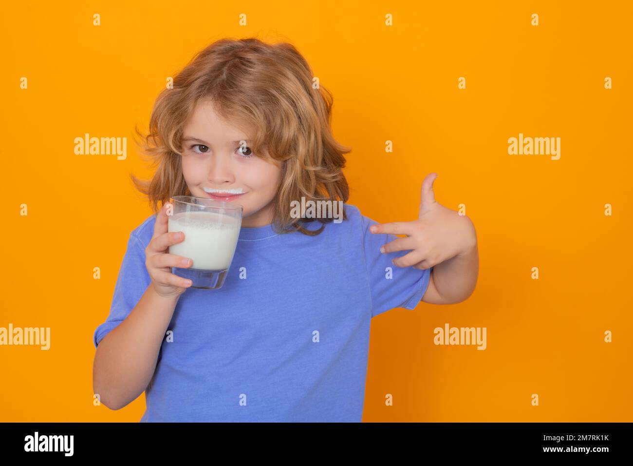 Kid drink milk with funny emotions on yellow background. Child drinking ...