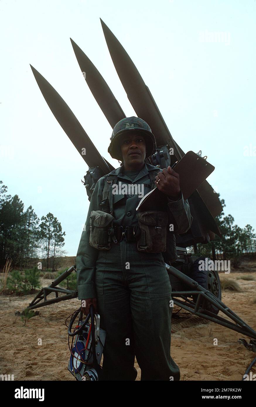 A female U.S. Army soldier carries test equipment away after inspecting ...