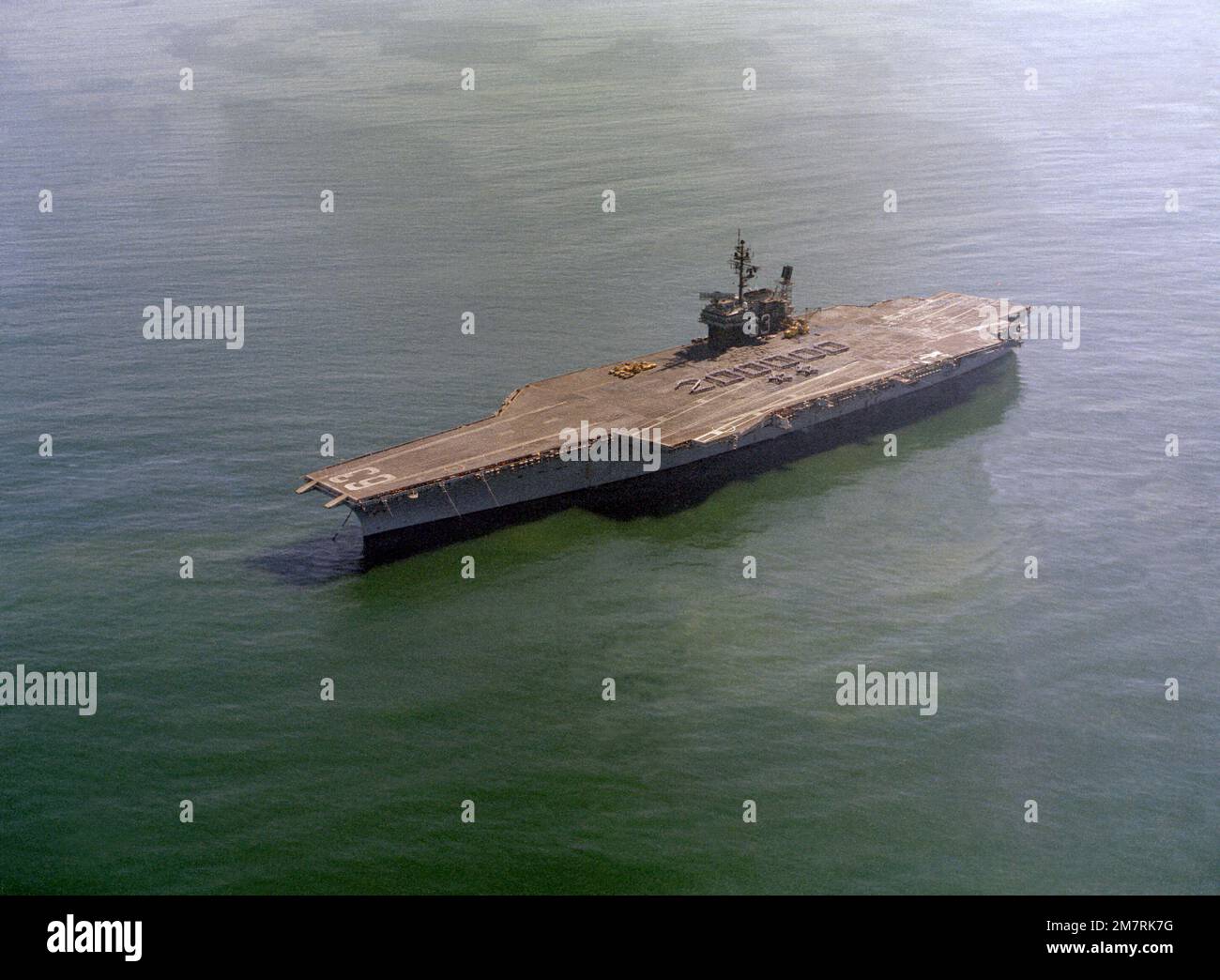 A port bow view of the USS KITTY HAWK (CV-63) as crewmen form the ...