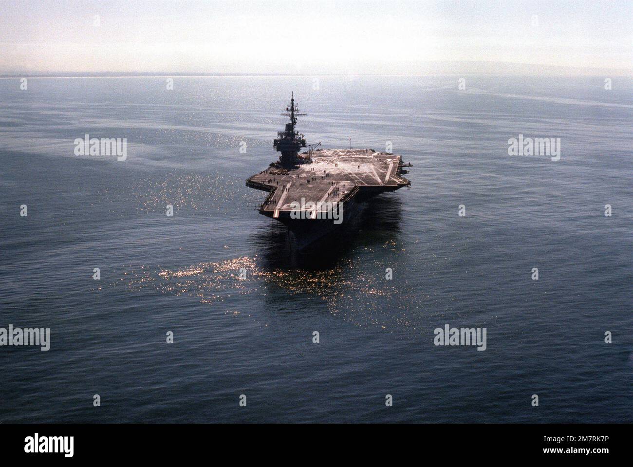 A bow view of the USS KITTY HAWK (CV-63) as crewmen form the number ...