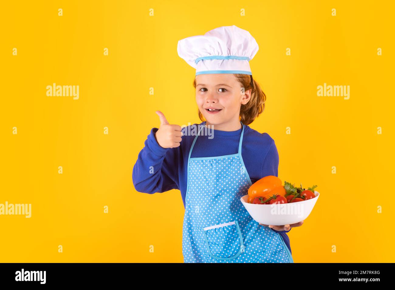 Kid cook hold plate with vegetables. Child cooking, little chef ...