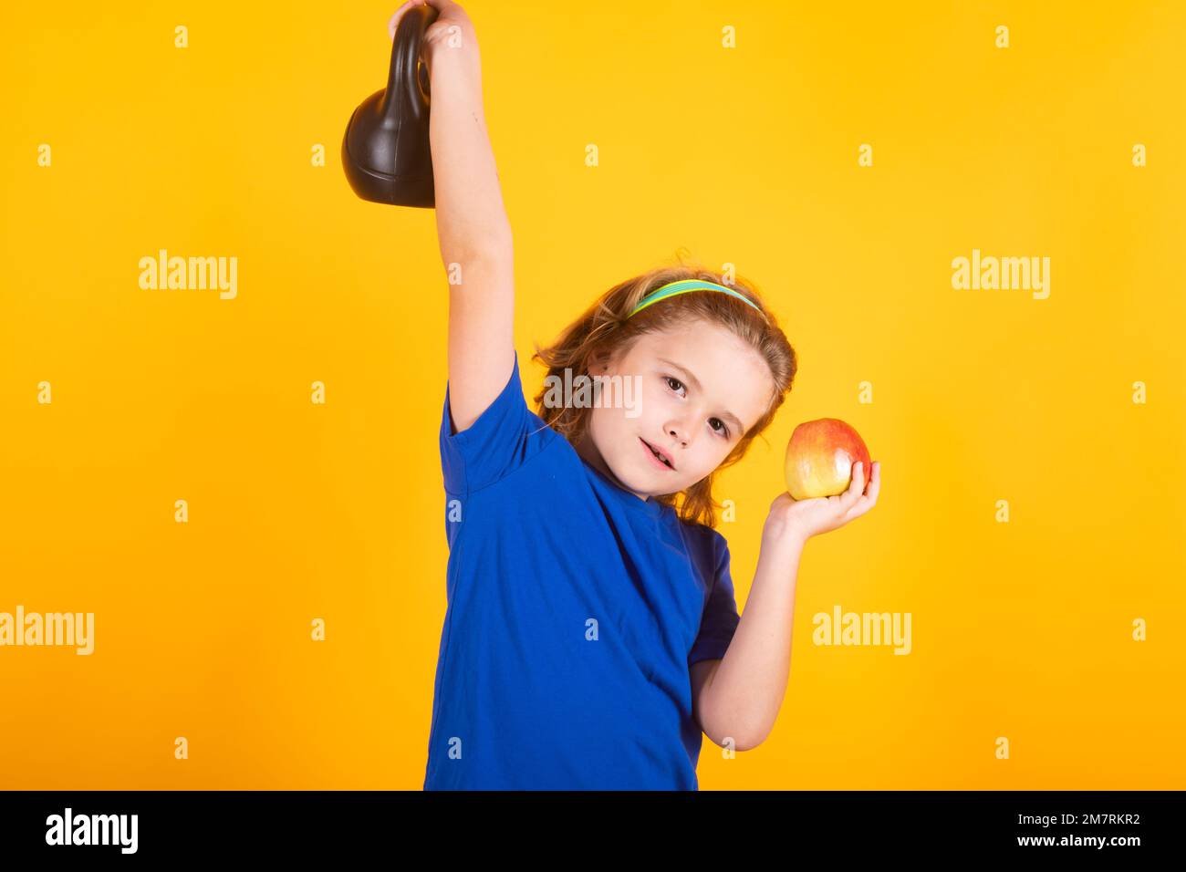 Kid raising a kettlebell. Cute child training with dumbbells. Kids ...