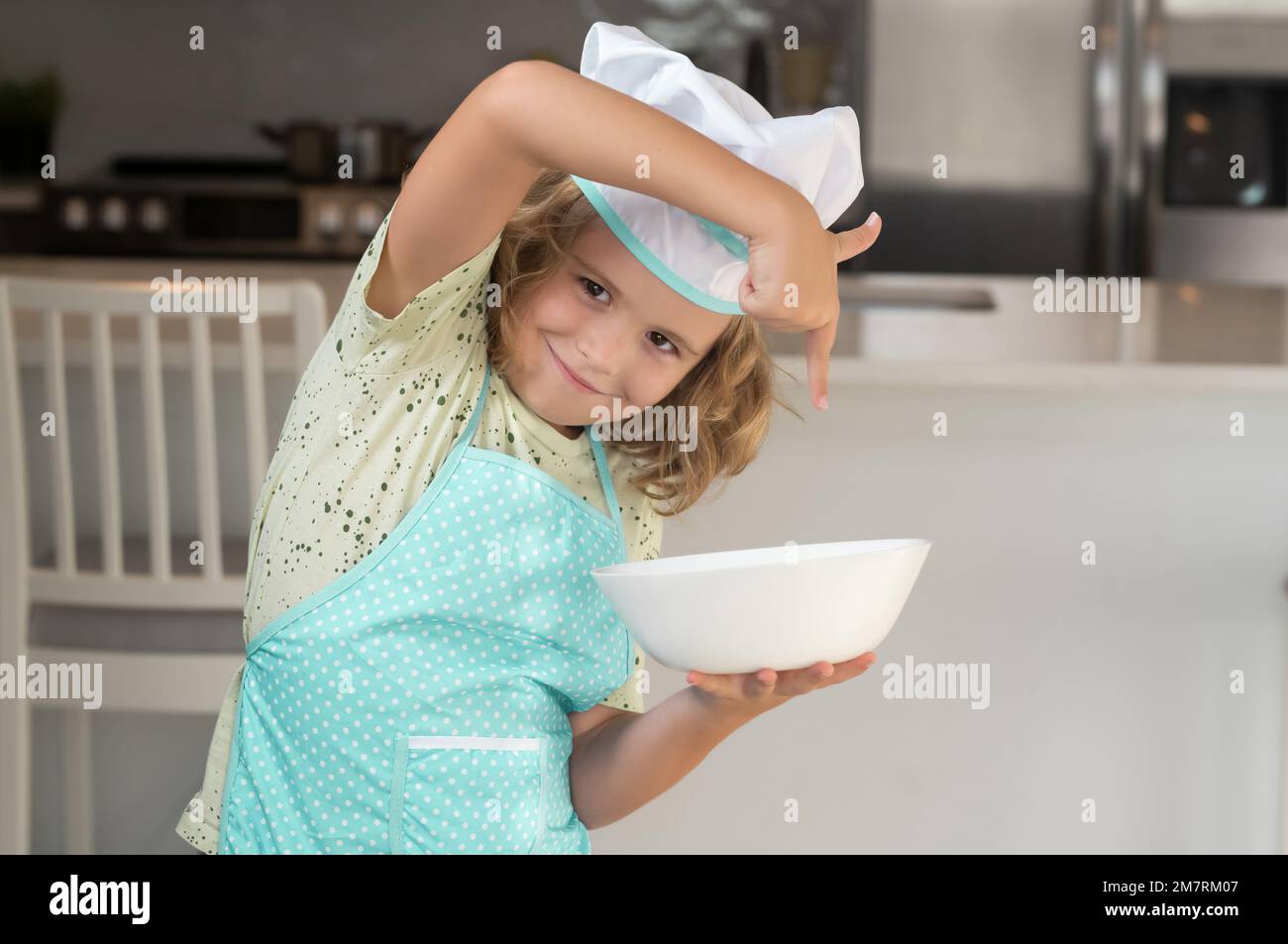Kid chef cook cookery at kitchen. Cute boy cooking in kitchen at home ...