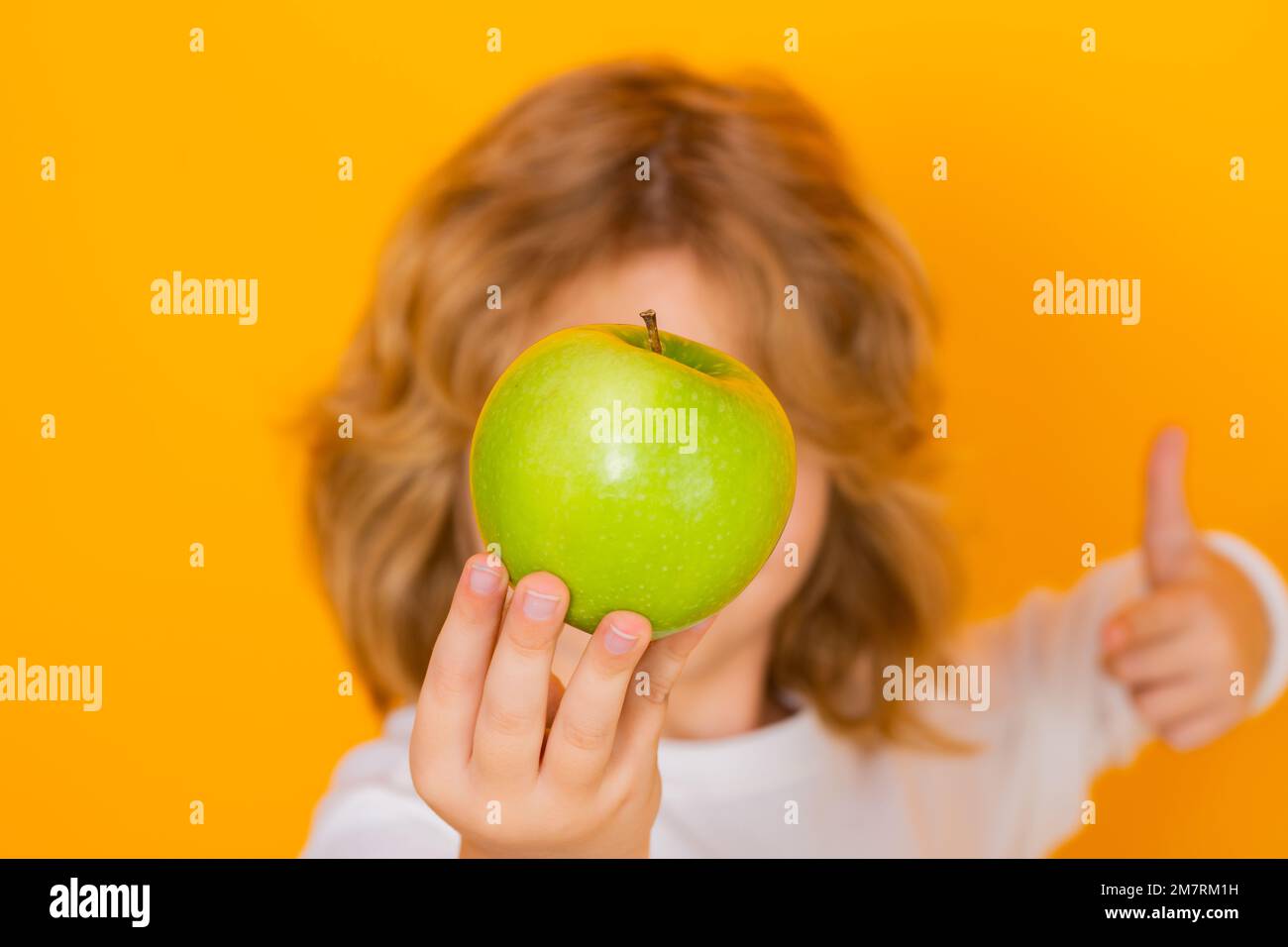 Kids face with fruits. Kid with apple in studio. Studio portrait of ...