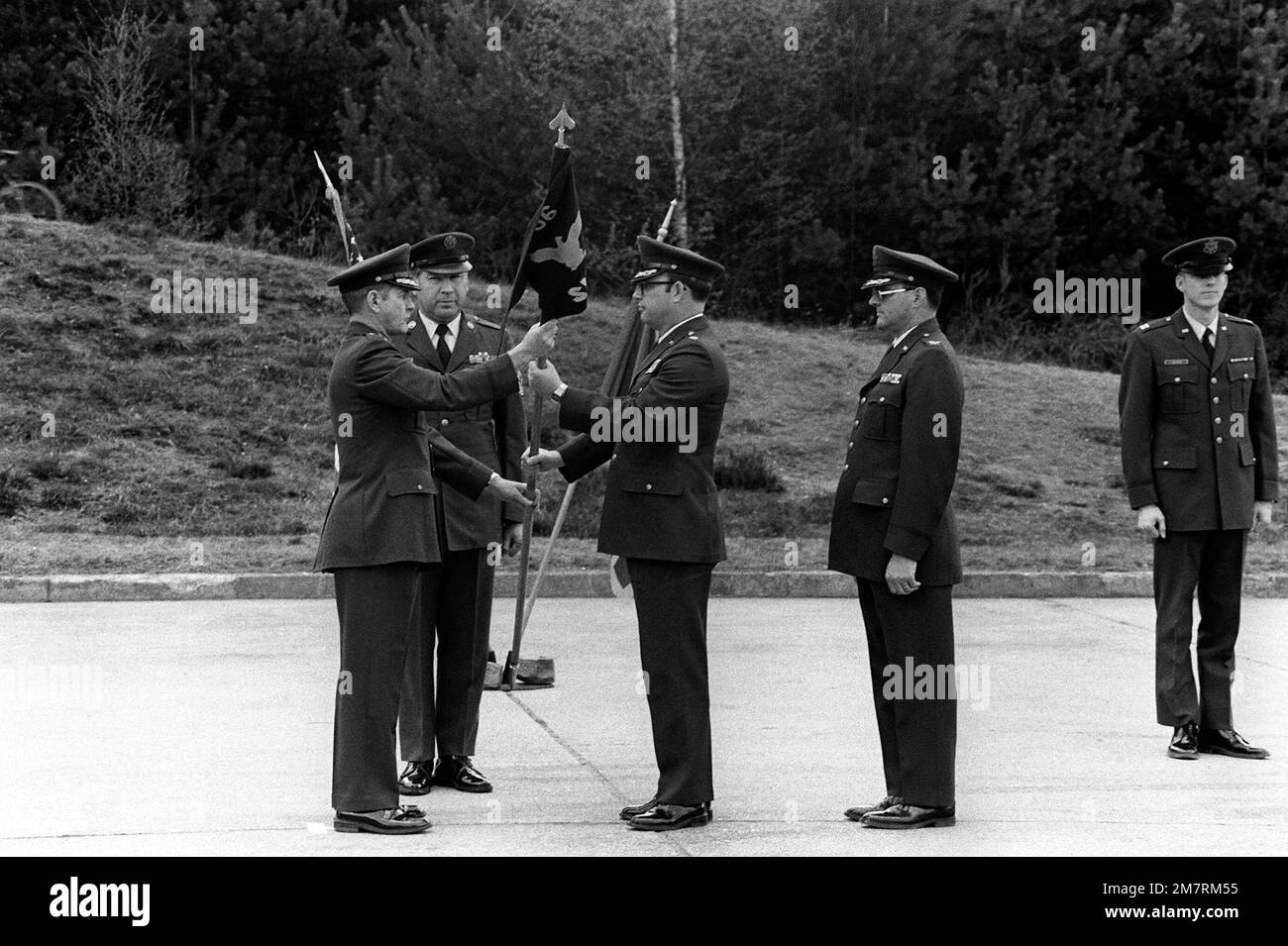 A unit flag is being transferred from BGEN Jerry W. Tietge, left, to ...