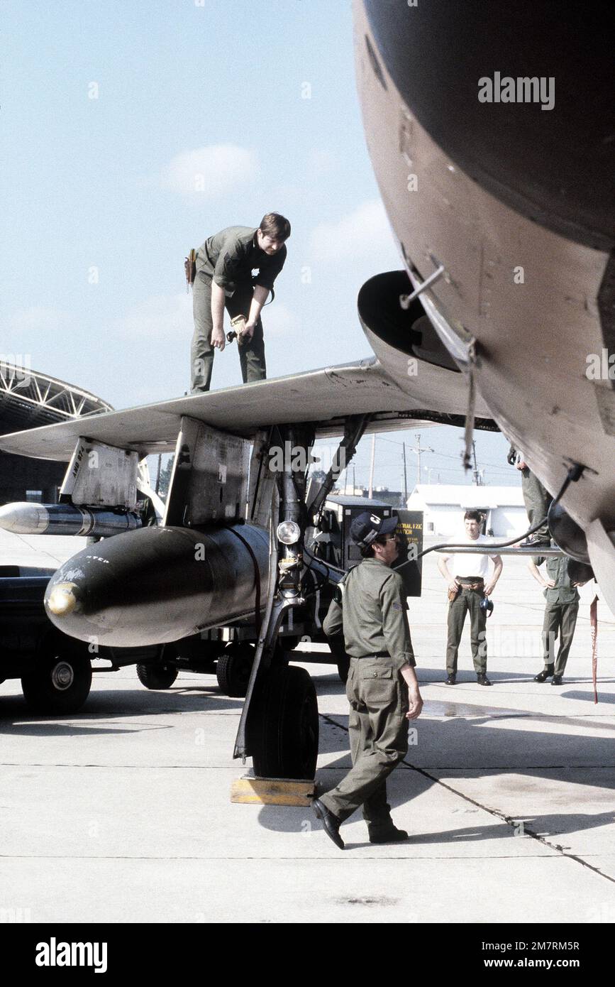 Airmen supply an F-105 Delta Dart aircraft with demineralized water ...
