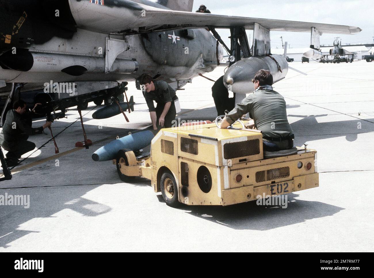 Airmen, with the aid of an MJ-1 bomb loader, load a 500-lb. Mark 82 ...