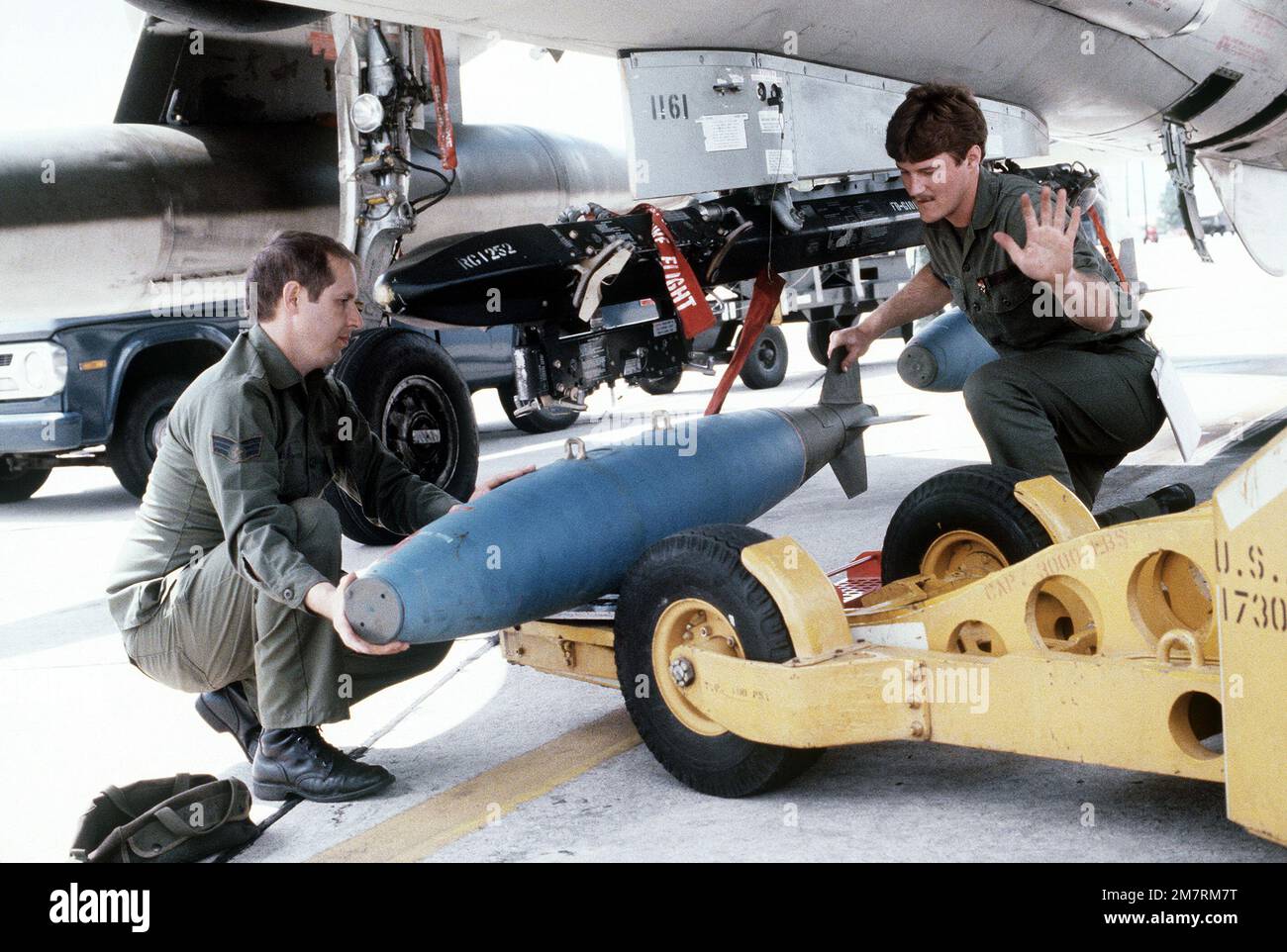 Airmen, with the aid of an MJ-1 bomb loader, load a 500-lb. Mark 82 ...