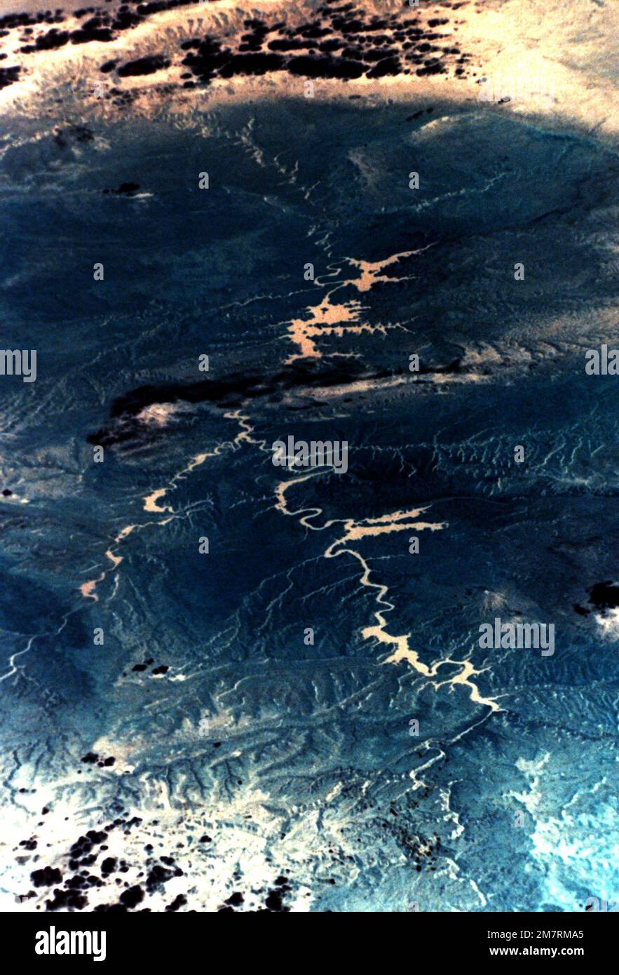 An outer space view of the Colorado River, surrounded by part of ...