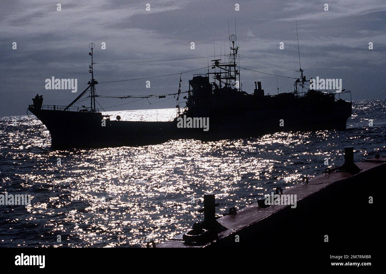 A port beam view of a Japanese fishing boat passing the island. Base ...