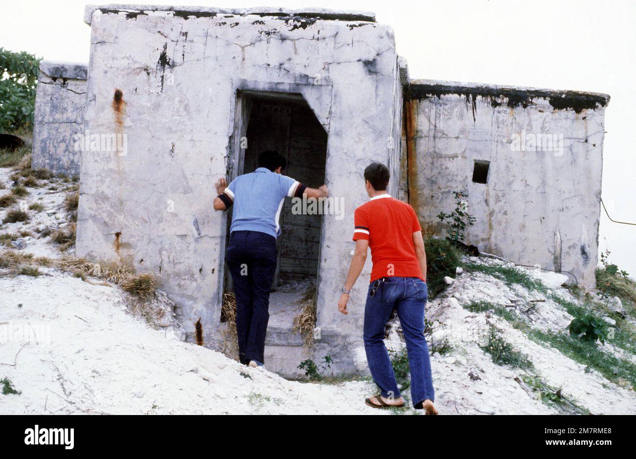 Two off duty members of the U.S. Air Force explore a Japanese bunker ...
