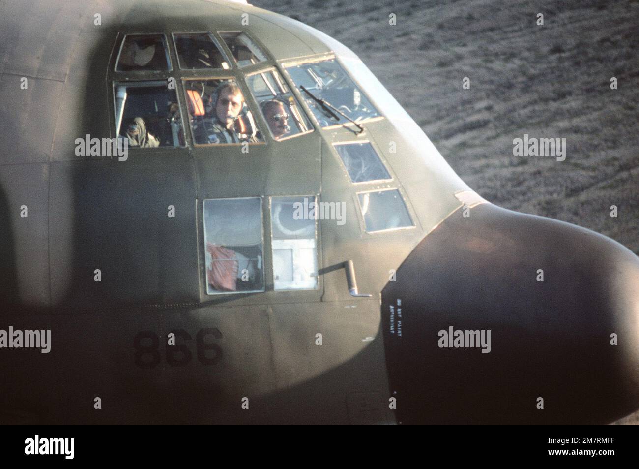 A close-up view of a C-130 Hercules aircraft front section. The ...