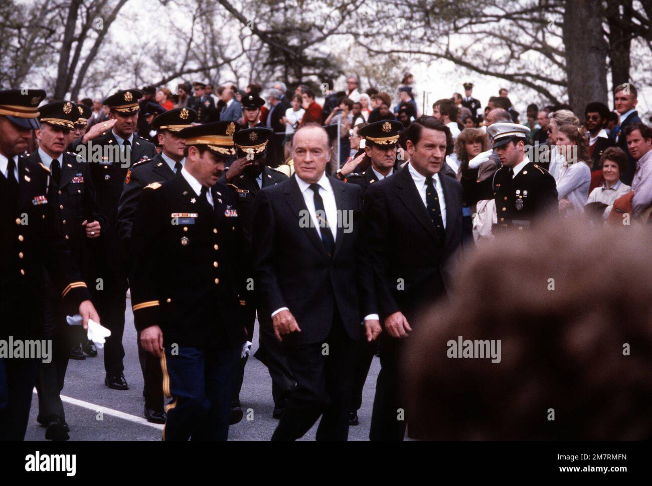 Bob Hope and joint-service officers leave the cemetery after the ...