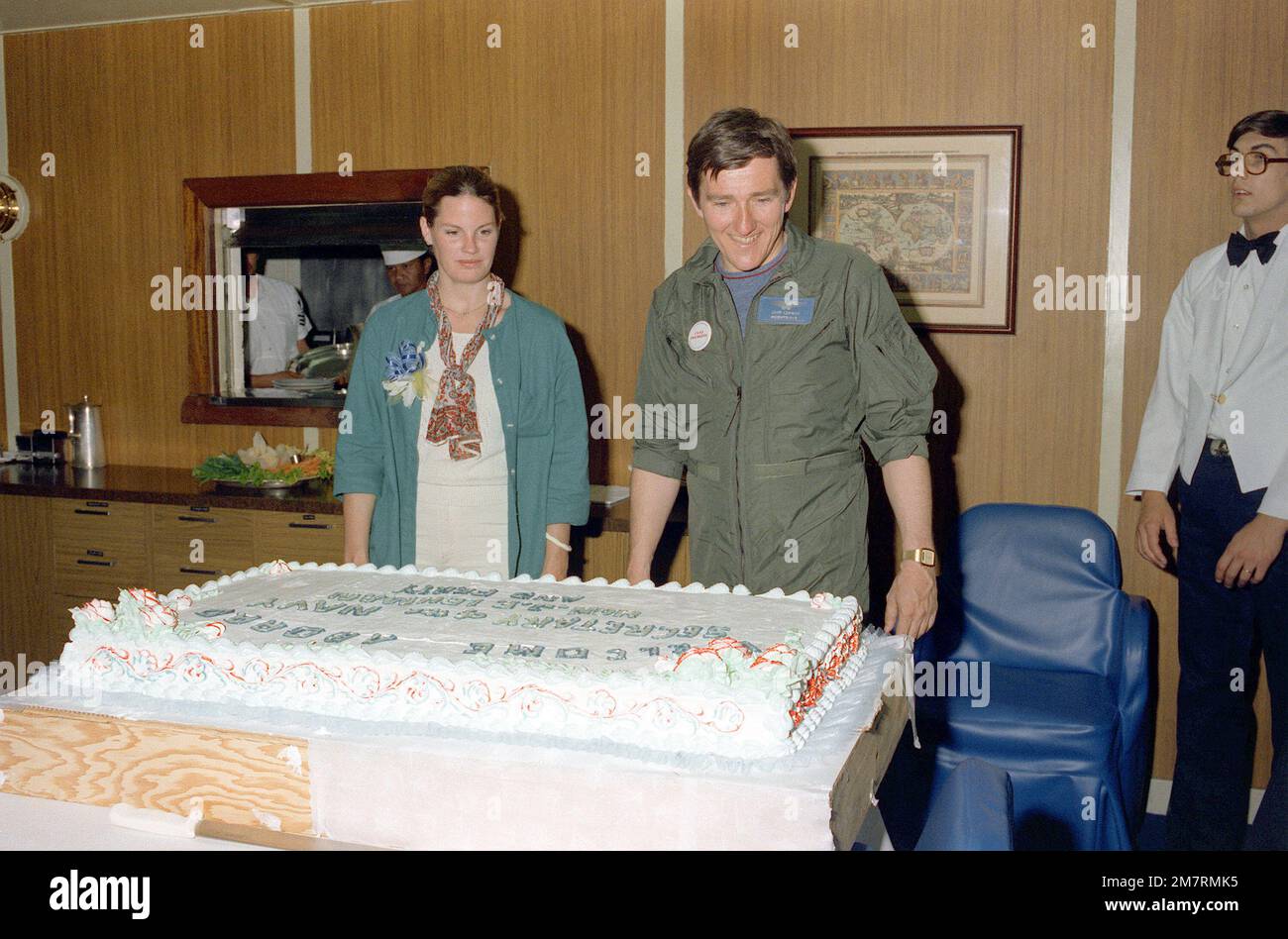 Secretary of the Navy John F. Lehman Jr. and his wife admire the cake ...