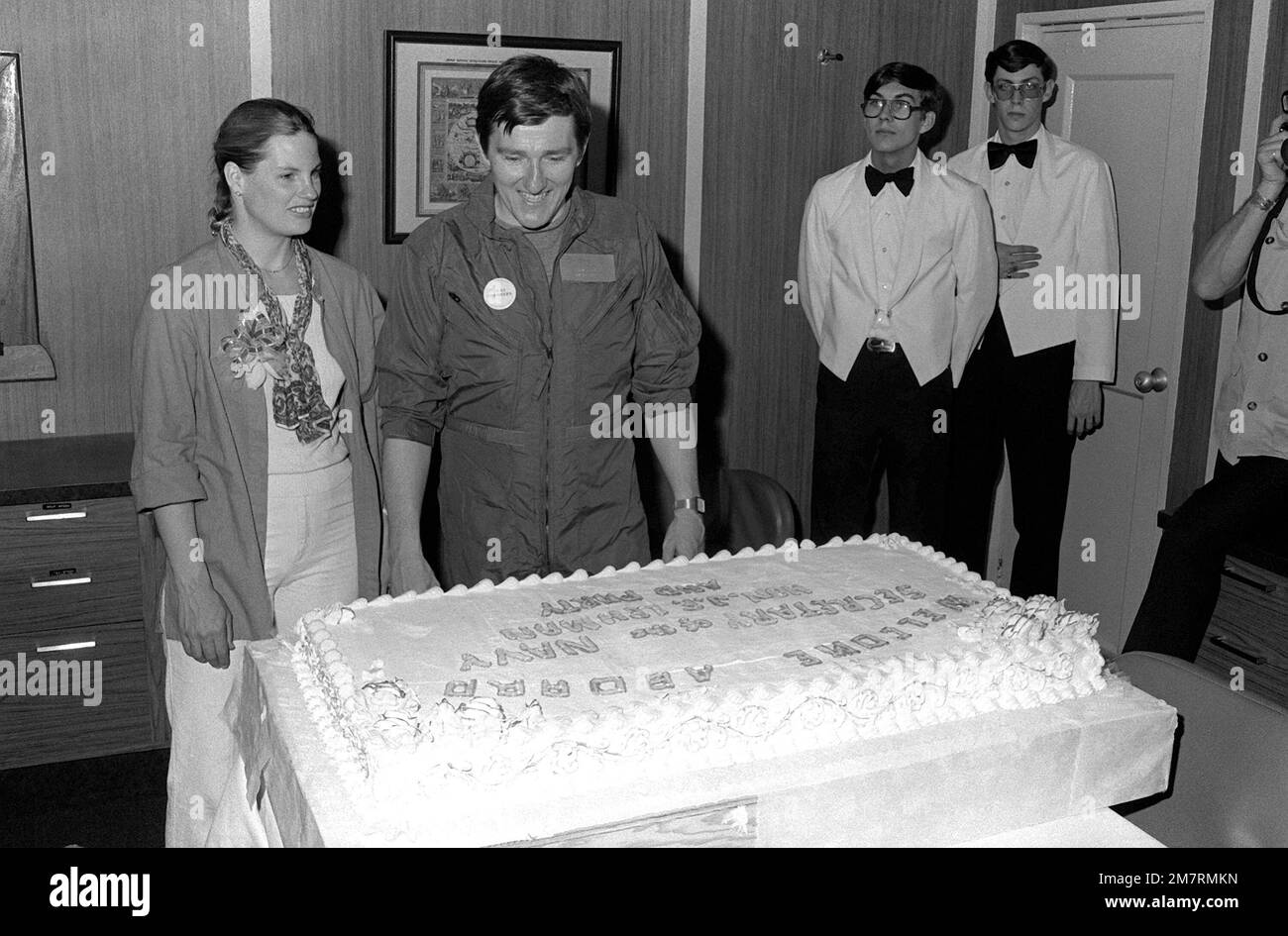 Secretary of the Navy John F. Lehman Jr. and his wife admire the cake ...