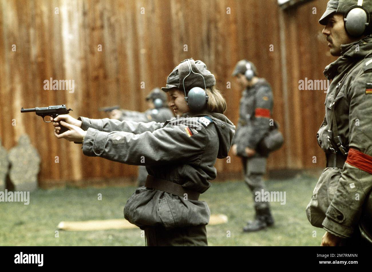 U.S. Air Force Academy cadets fire German 9mm pistols at a pistol range ...
