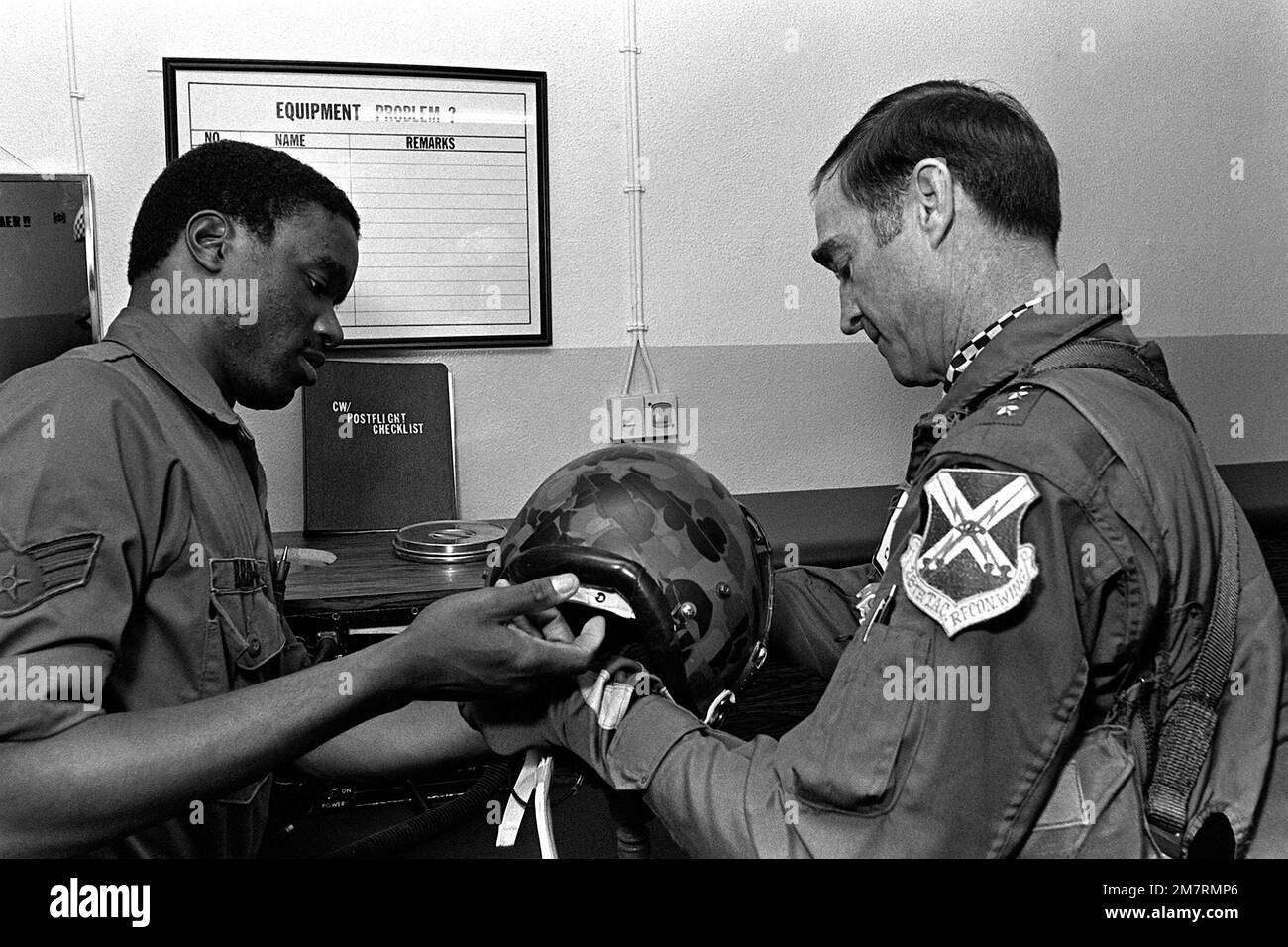 GEN. Charles A Gabriel picks up a flight helmet from SENIOR AIRMAN ...