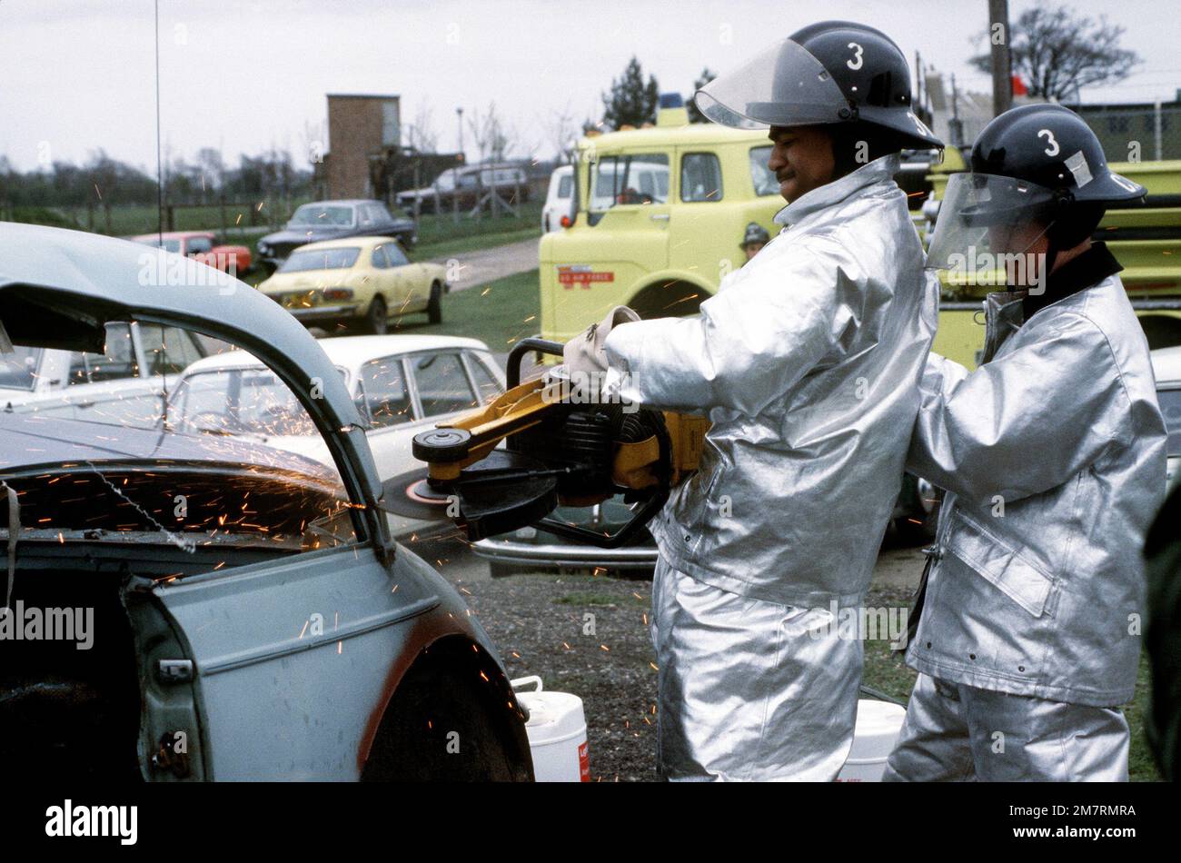 Firemen use a K-12 circular saw to cut off the top of a car during ...