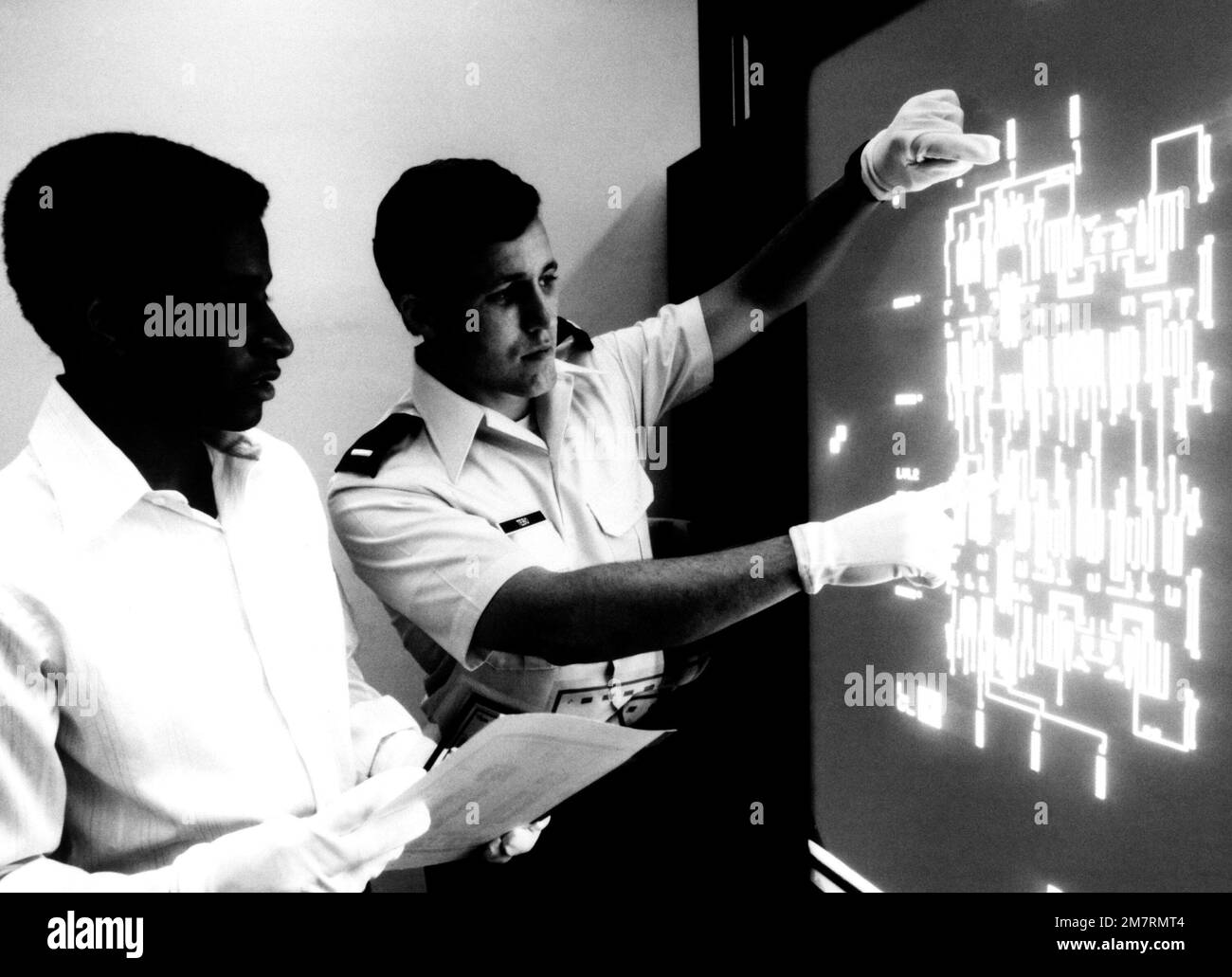 Technicians use a lithographic print to outline a schematic for ...