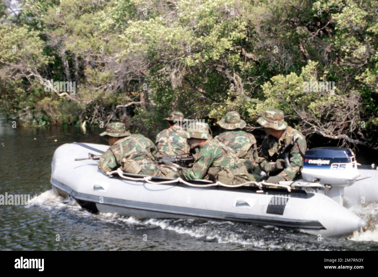 Combat control team members, armed with GAU-5 assault rifles, maneuver ...