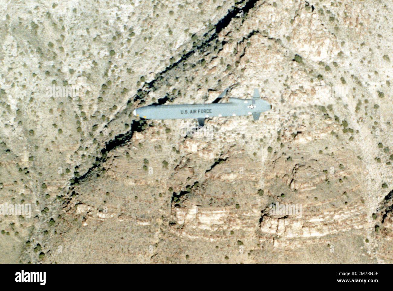 AN air-to-air side view of an AGM-86 air-launched cruise missile near ...