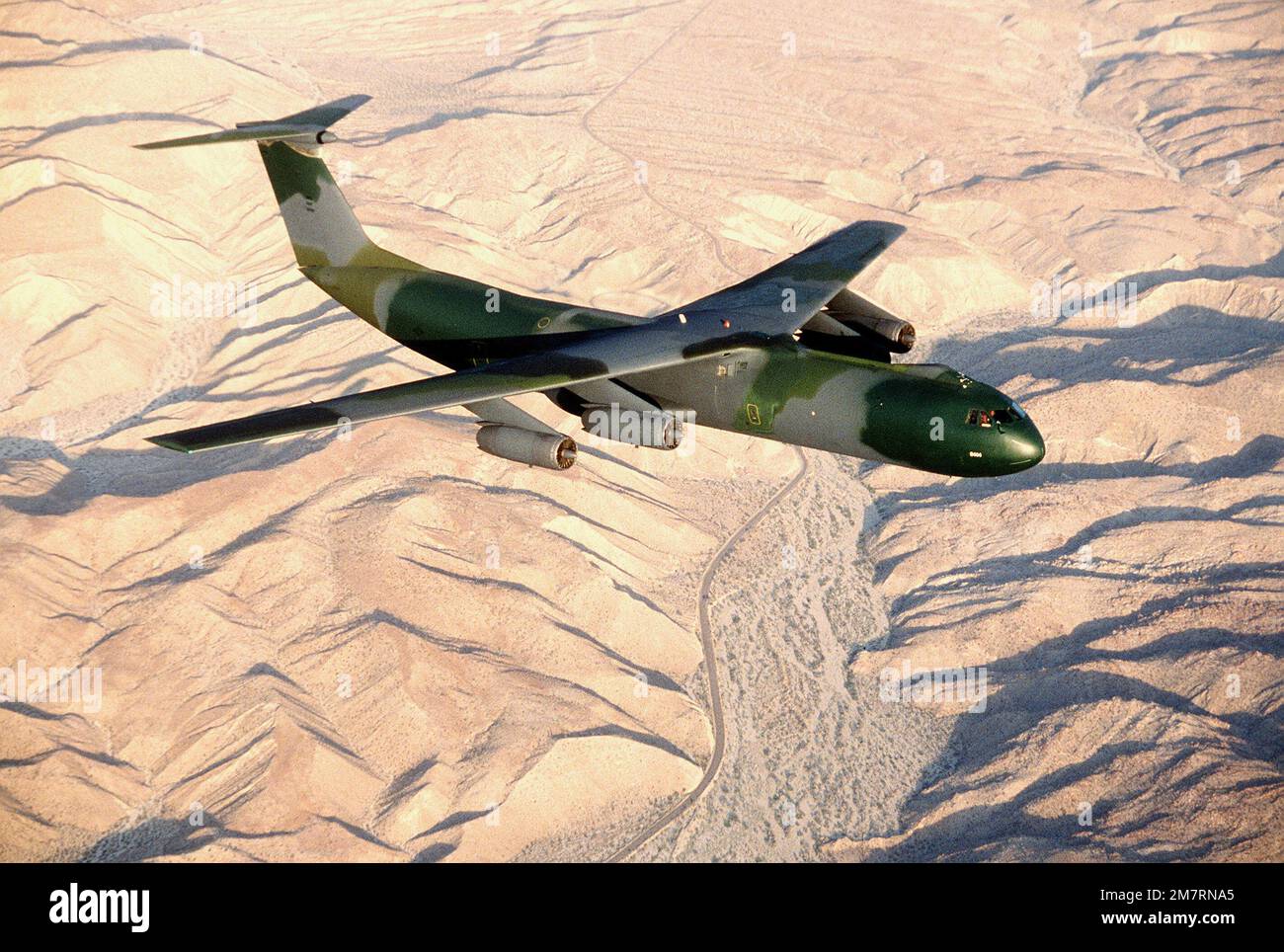 AN air-to-air right front view of a C-141B Starlifter aircraft with the ...
