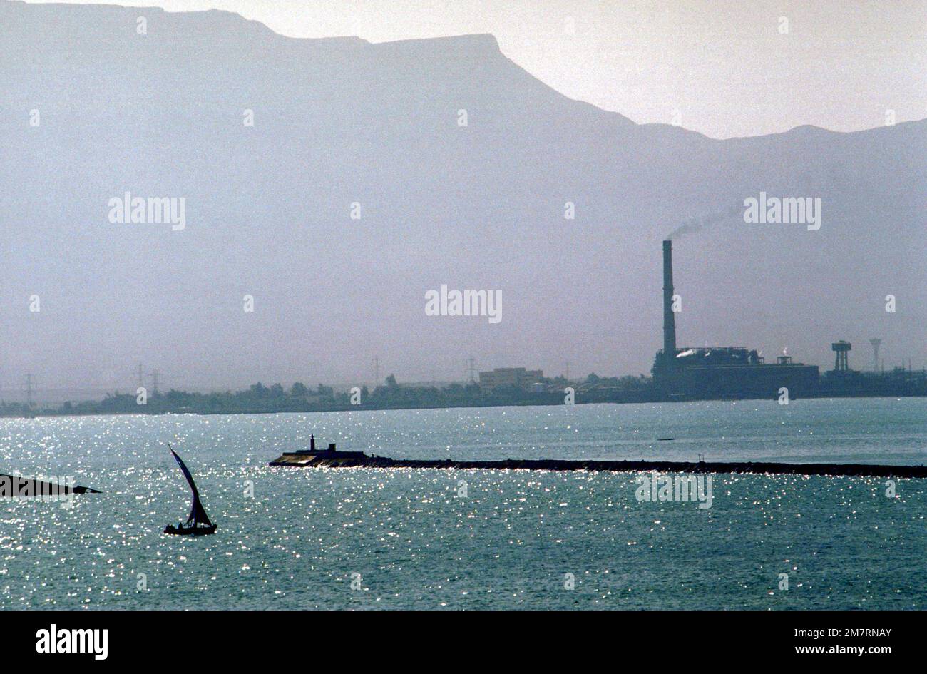 A silhouetted view of the city of Suez and its gulf. State: Suez Canal ...